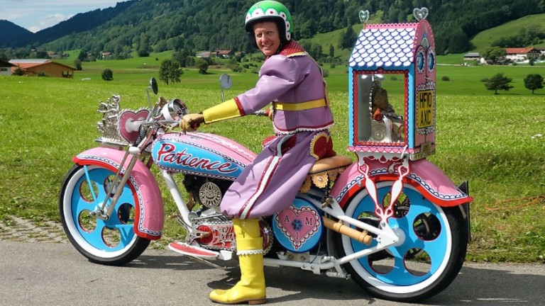 Grayson Perry’s Pink Motorbike Pilgrimage with his Teddybear in a ...